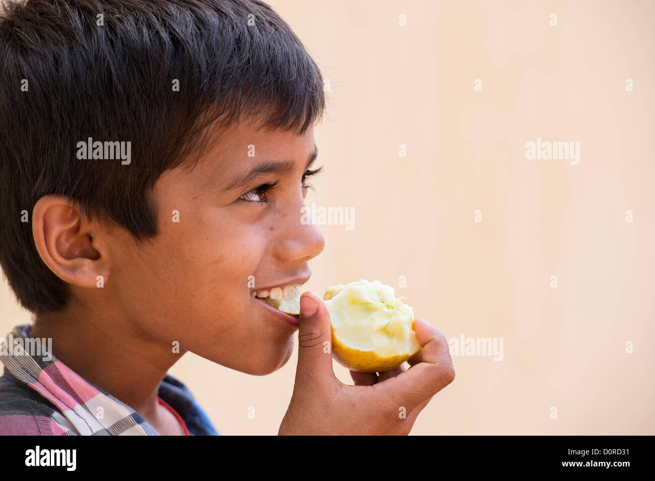 Young indian boy eating an apple. Andhra Pradesh, India Stock Photo - Alamy