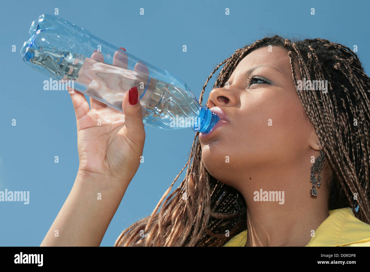black african girl drinks a water Stock Photo - Alamy
