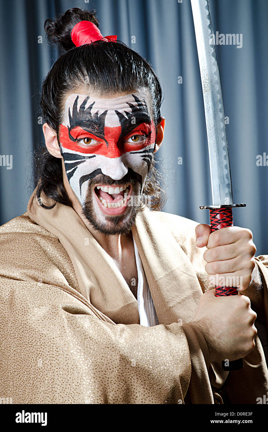 Man with face mask and sword Stock Photo - Alamy