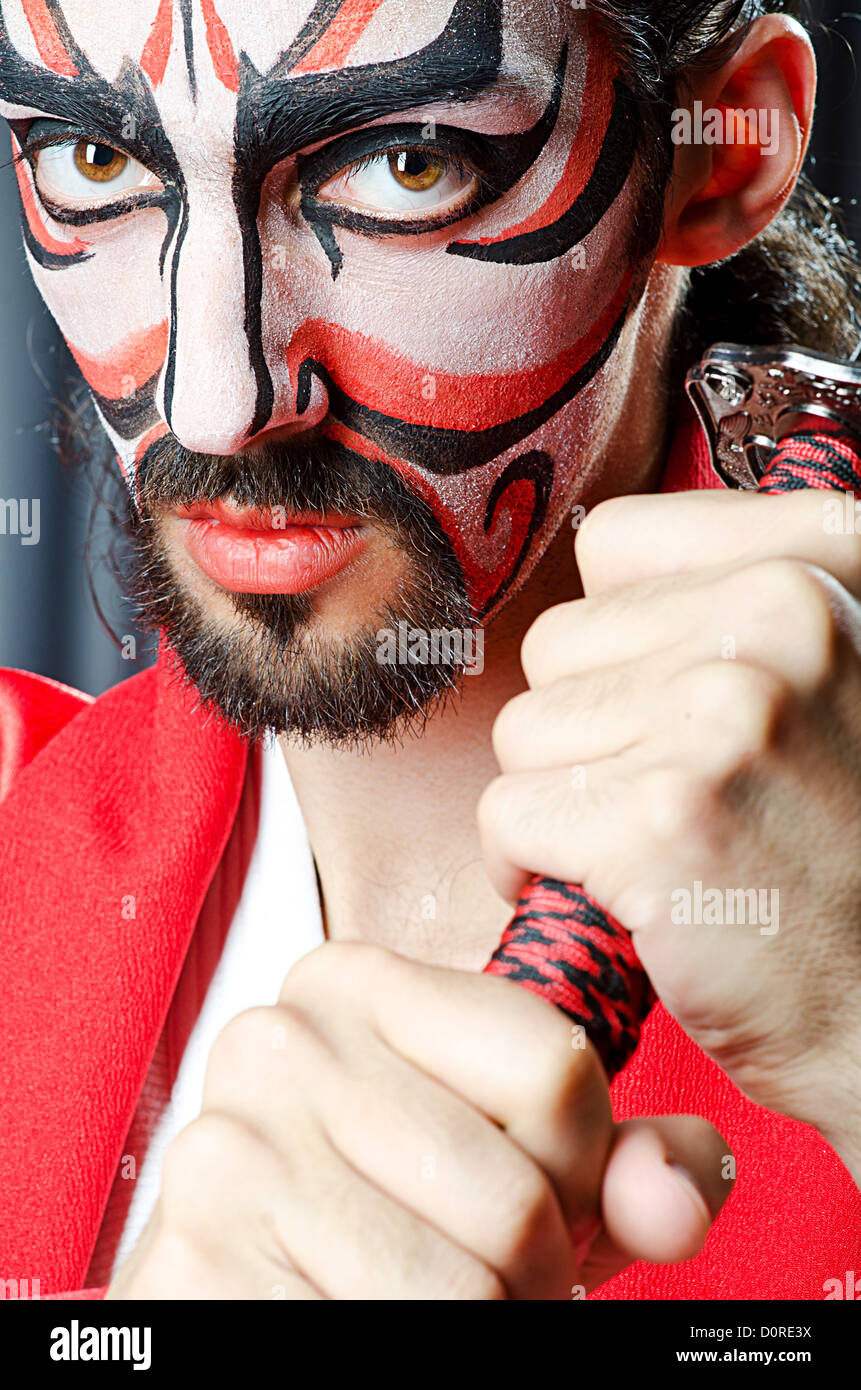 Man with face mask and sword Stock Photo - Alamy