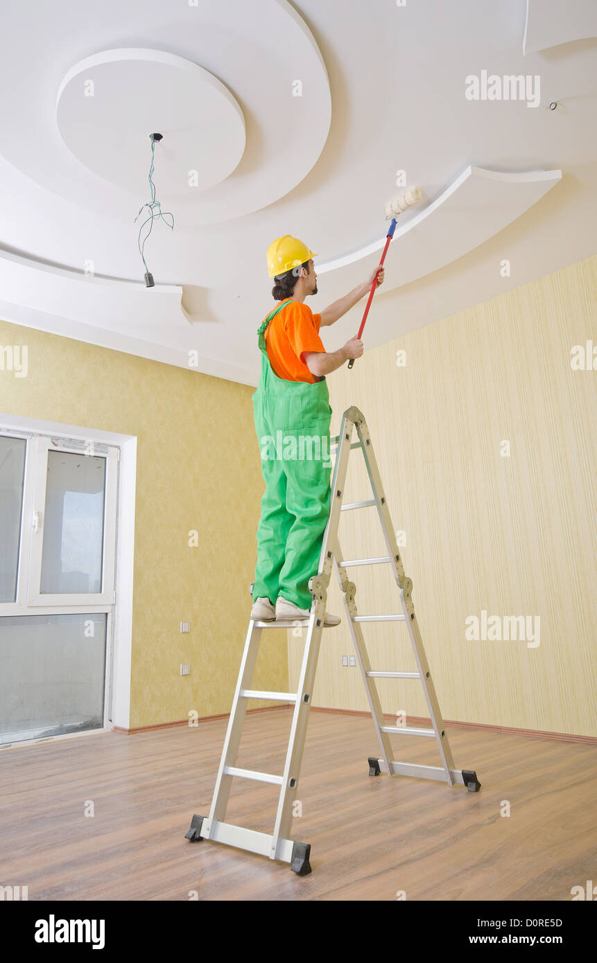 Painter worker during painting job Stock Photo - Alamy