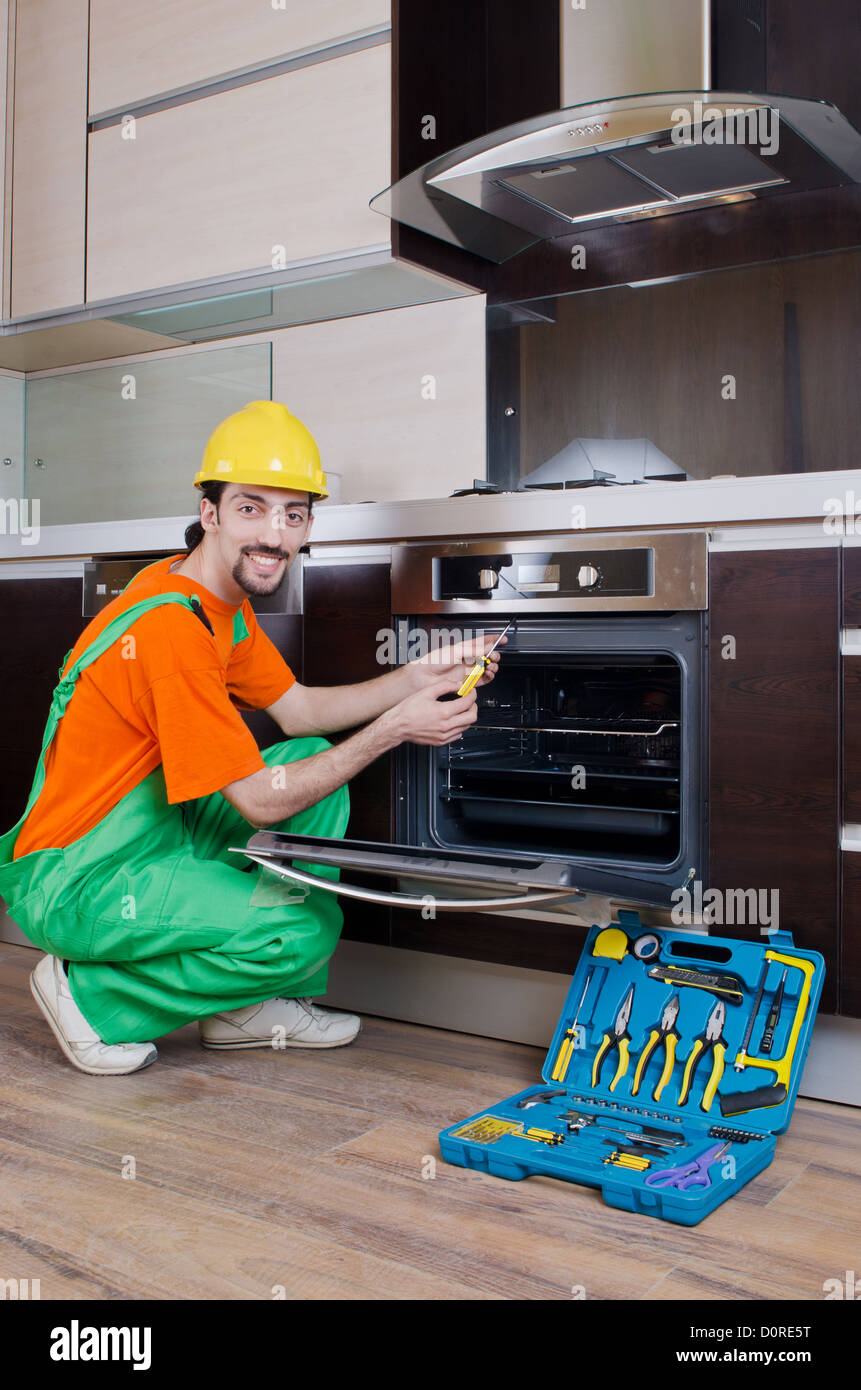 Repairman assembling the furniture at kitchen Stock Photo - Alamy