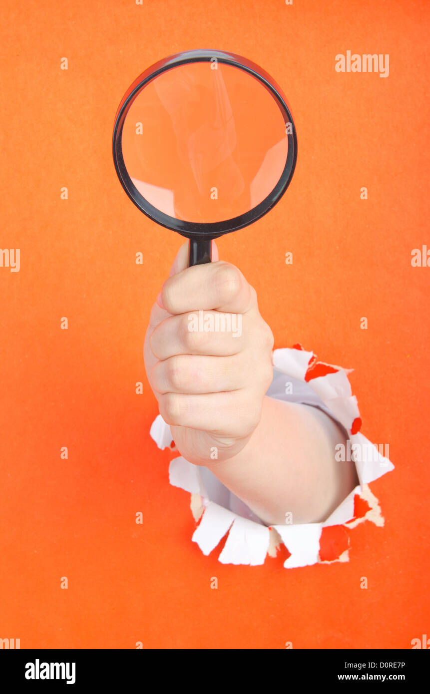 Hand holding magnifying glass Stock Photo - Alamy