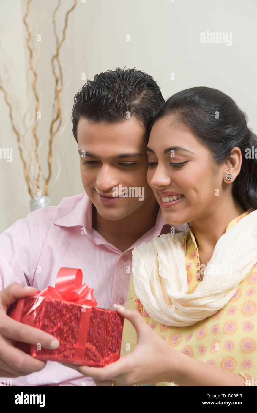 Man giving a present to a woman Stock Photo - Alamy