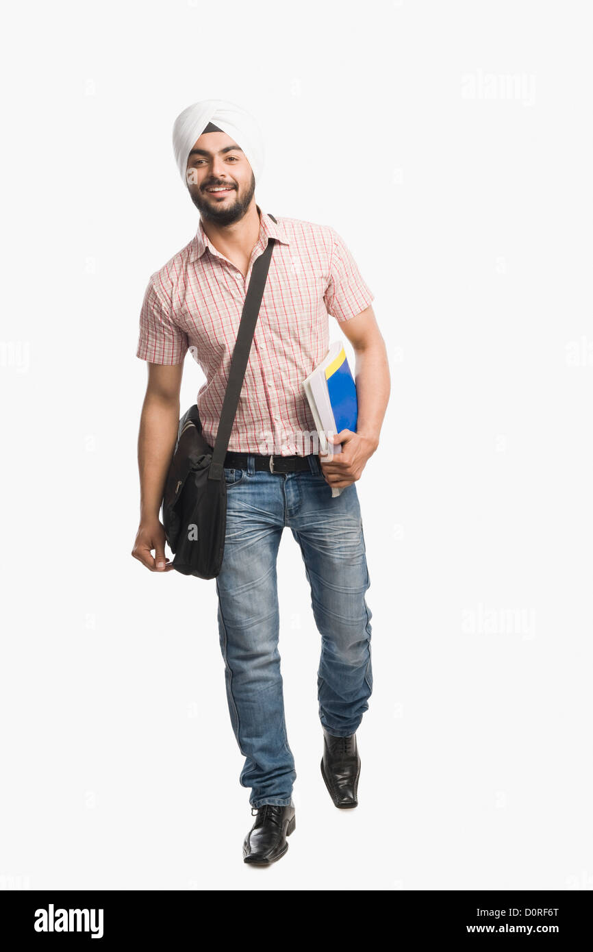 Indian college student holding book Cut Out Stock Images & Pictures - Alamy