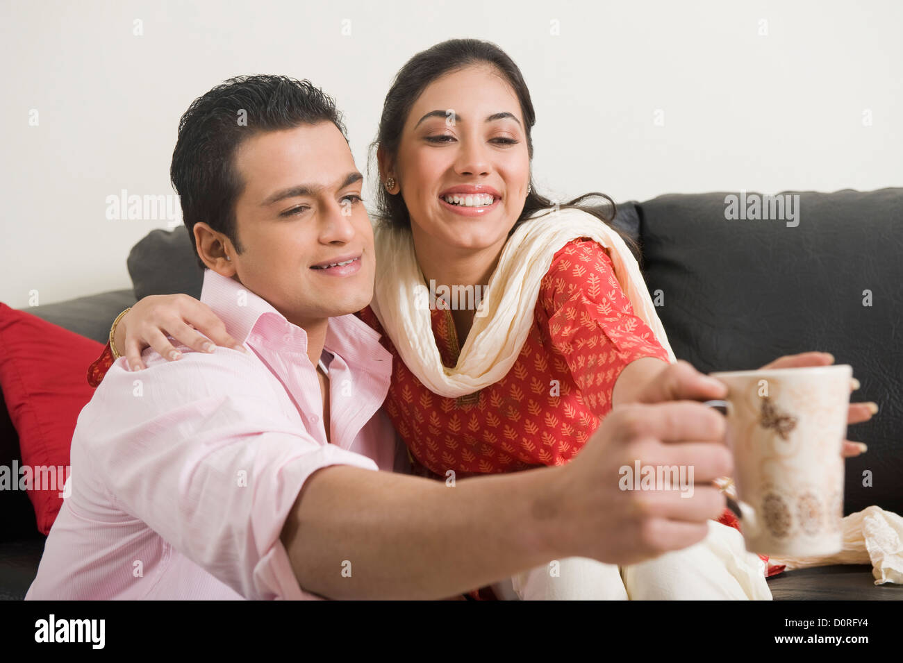 Couple having fun with a cup of coffee Stock Photo - Alamy