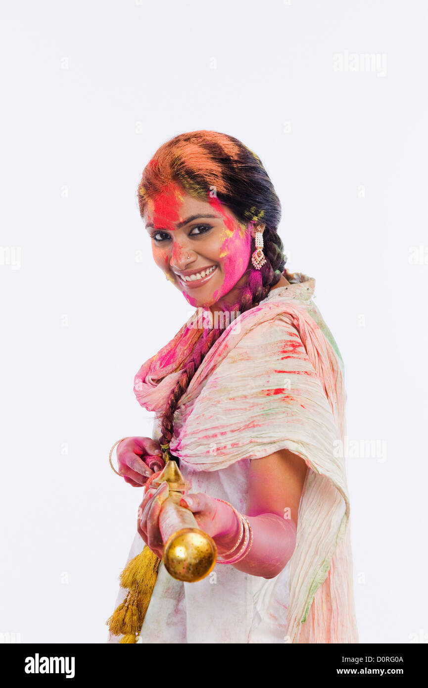 Woman playing Holi with a pichkari Stock Photo - Alamy
