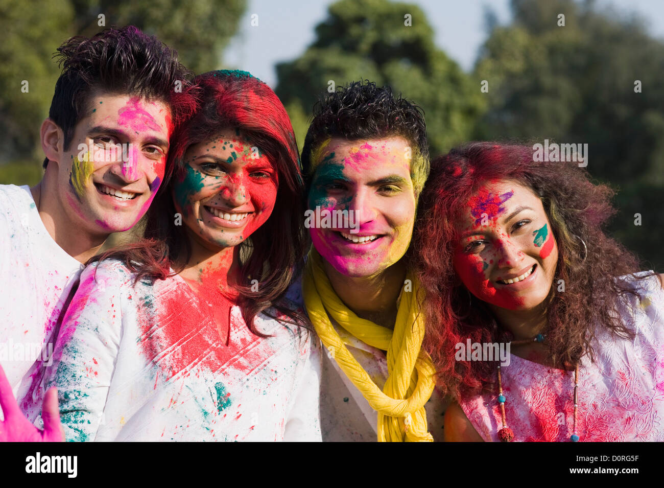 Friends celebrating Holi Stock Photo - Alamy