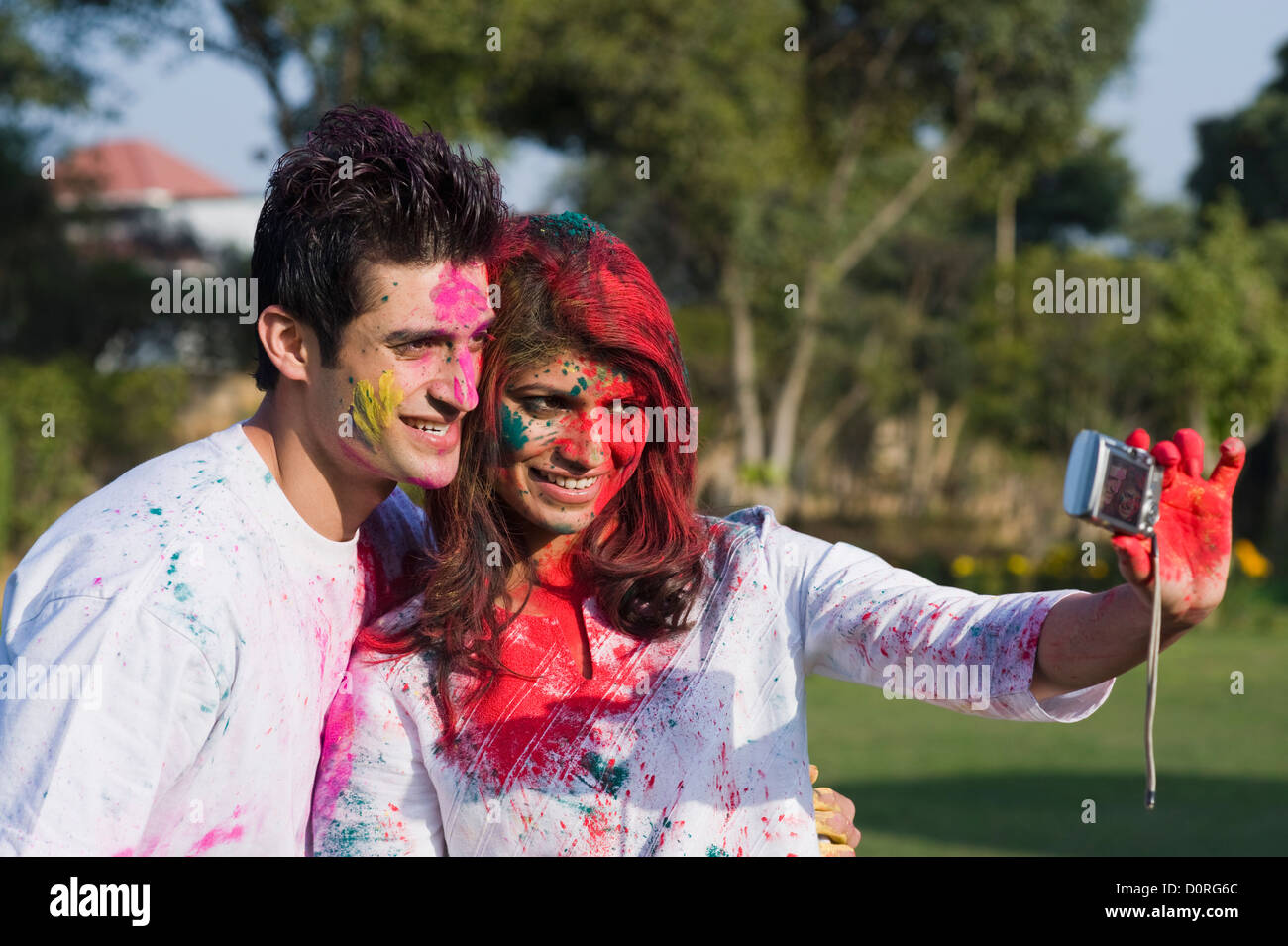 Couple taking a picture of themselves with a camera on Holi Stock Photo ...