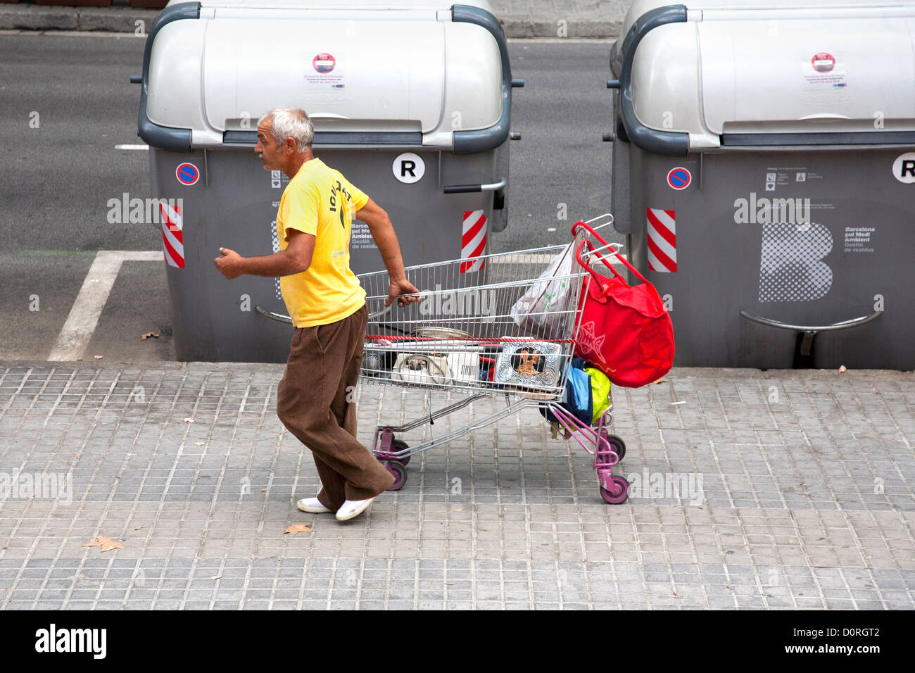 Man collecting scrap metal in supermarket trolley Stock Photo - Alamy