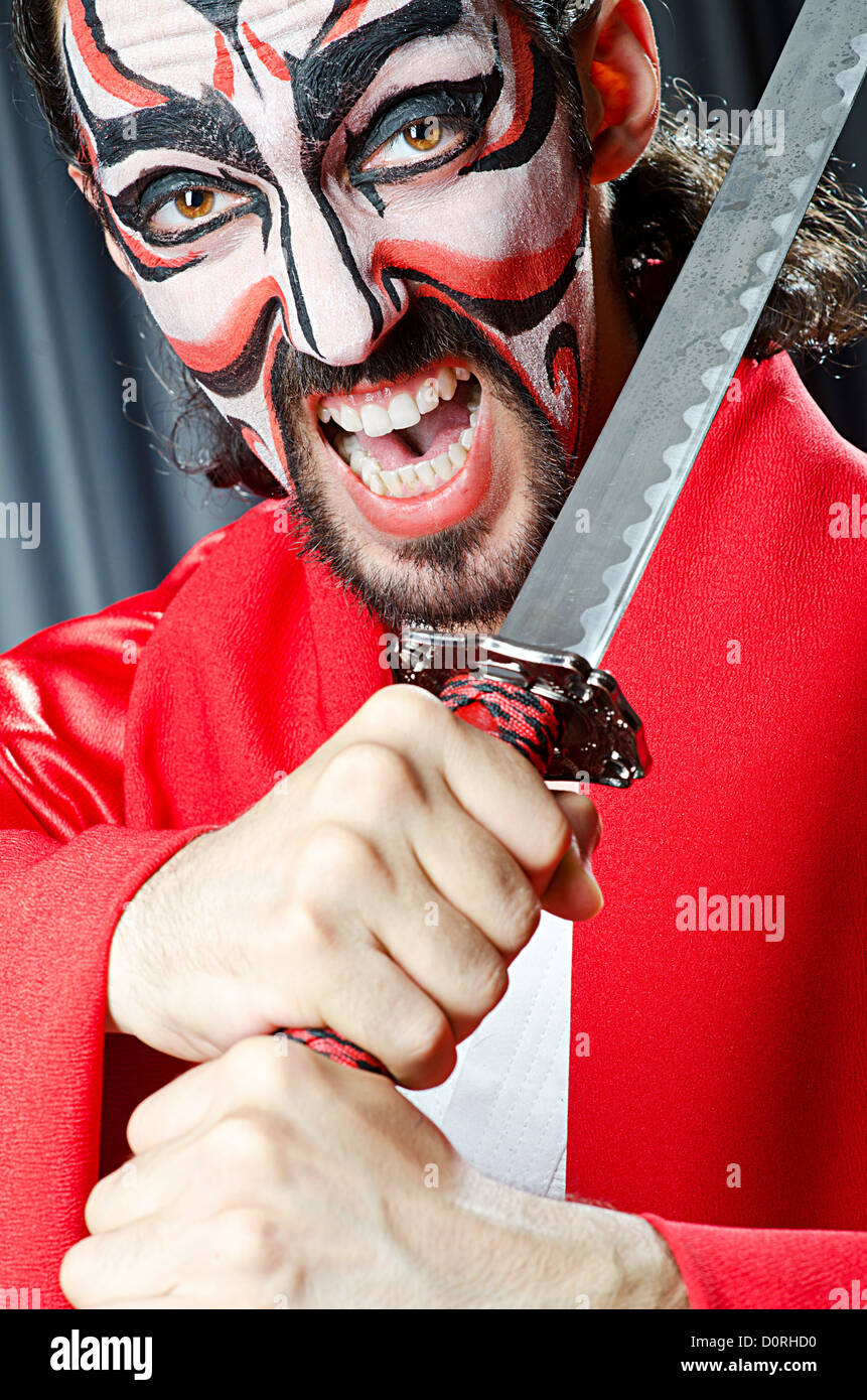 Man with face mask and sword Stock Photo - Alamy