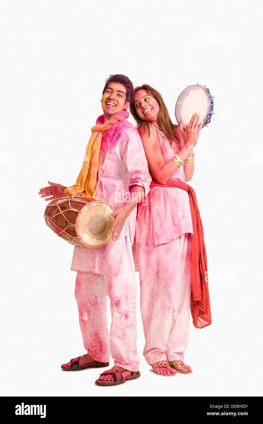 Couple celebrating Holi with musical instruments Stock Photo - Alamy