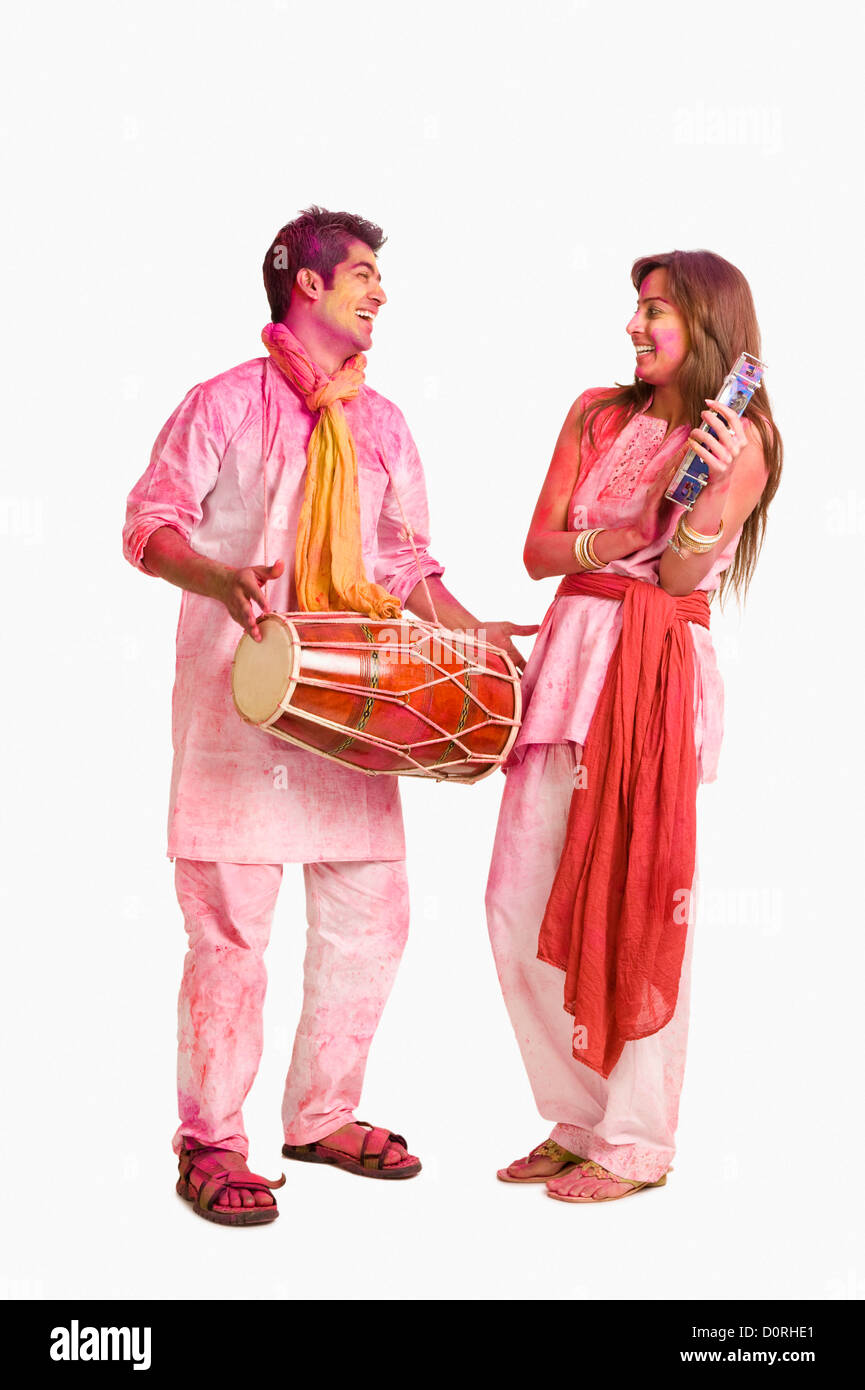 Couple celebrating Holi with musical instruments Stock Photo - Alamy