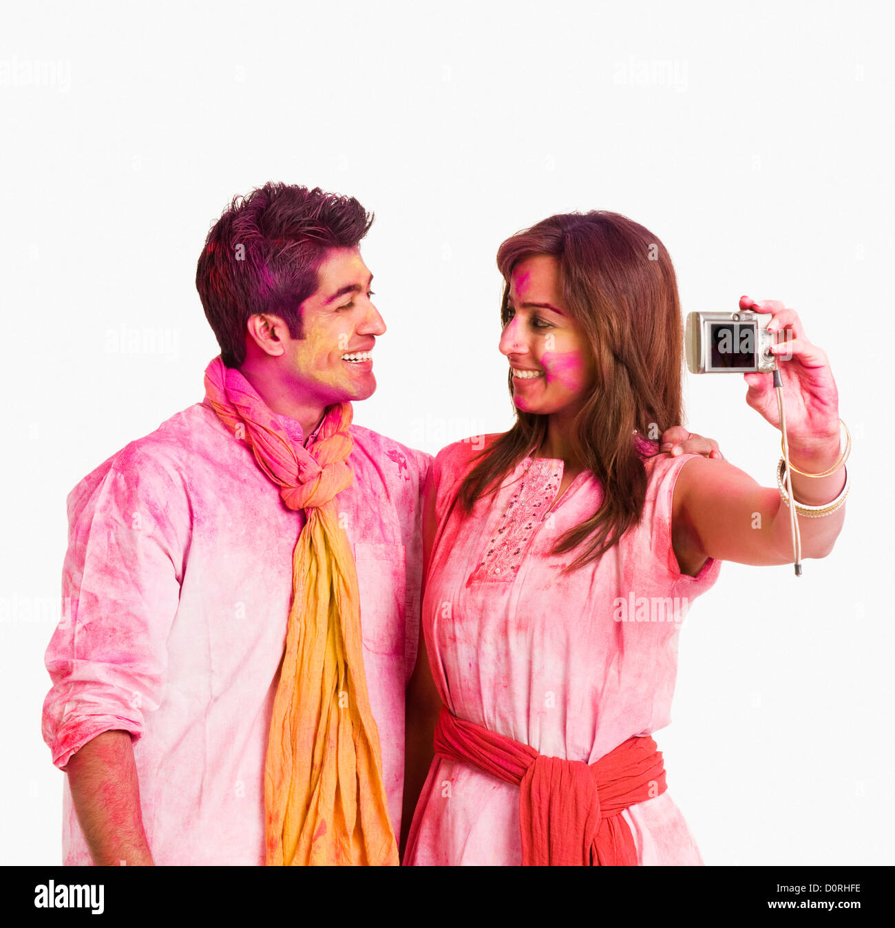 Couple taking a picture of themselves with a camera on Holi Stock Photo ...
