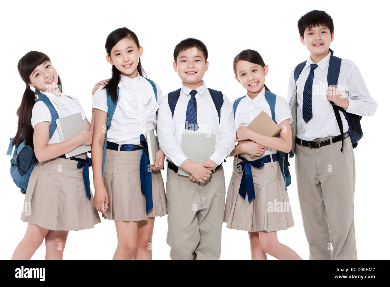 Happy primary school friends with books and schoolbags Stock Photo - Alamy