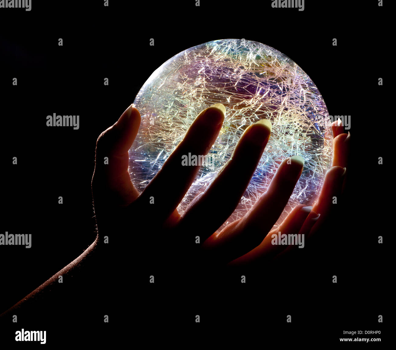 Hands holding a glowing colorfull glass or crystal ball Stock Photo - Alamy