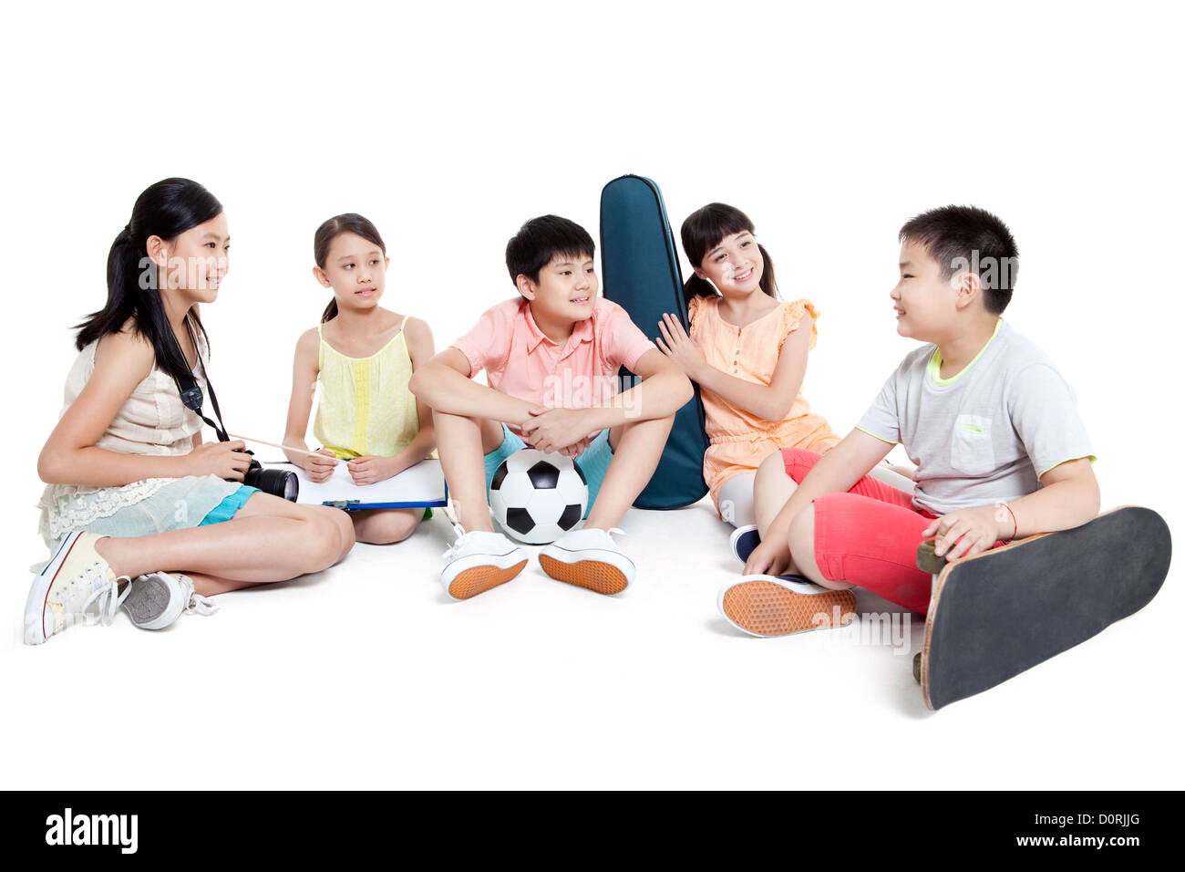 Merry children sitting on the floor and their leisure hobbies Stock ...