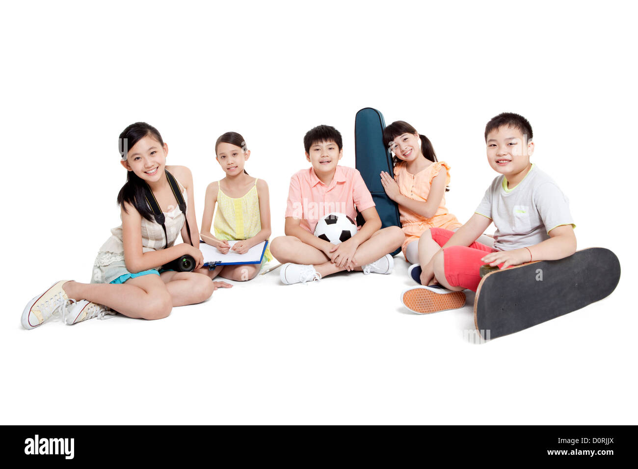Merry children sitting on the floor and their leisure hobbies Stock ...