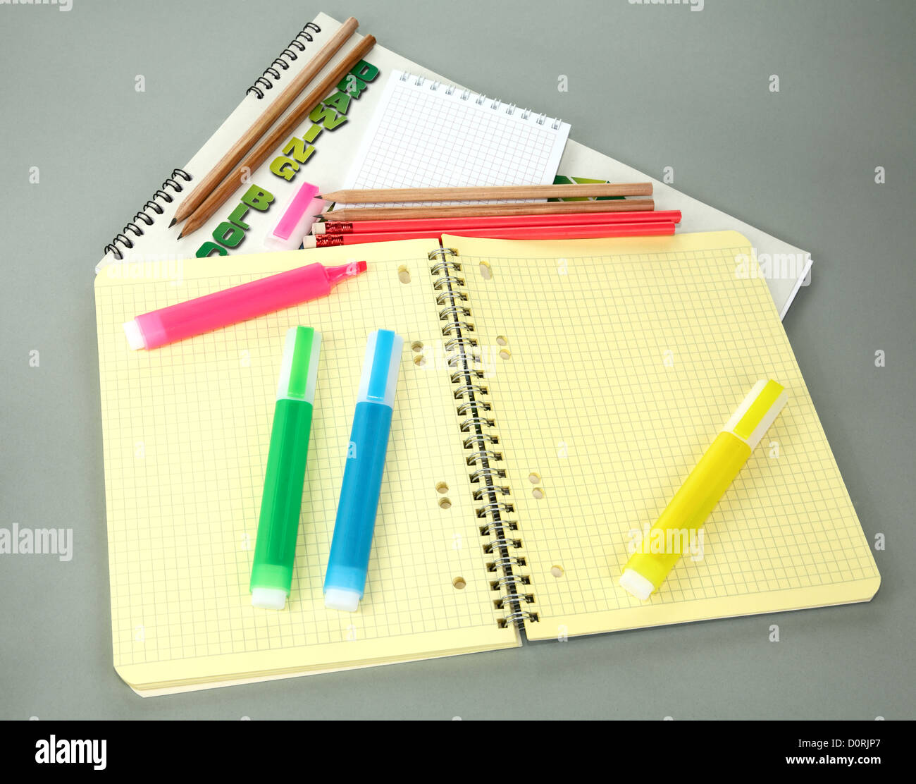 Markers pencils a writing-book Stock Photo - Alamy