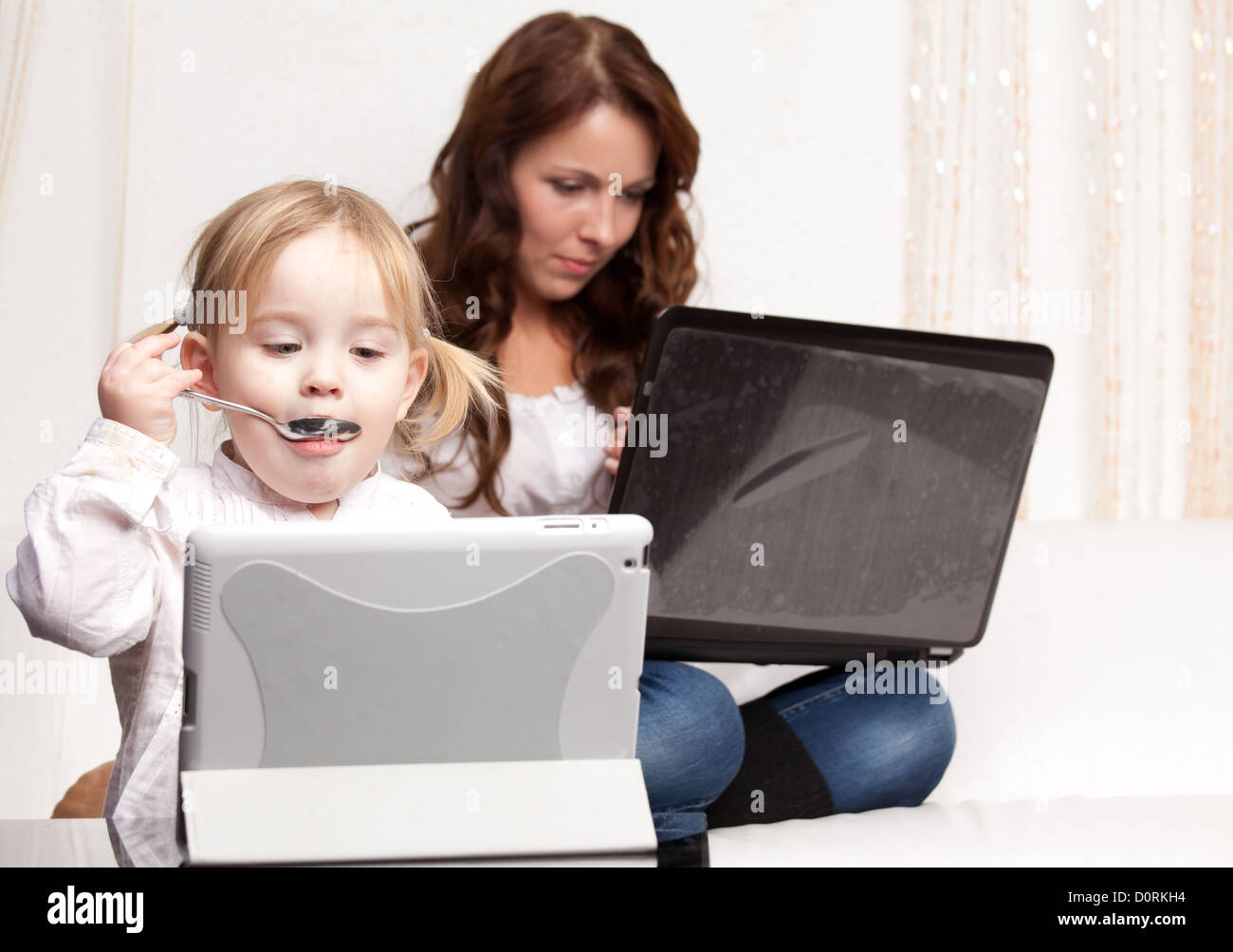 Mother and baby with laptop Stock Photo - Alamy