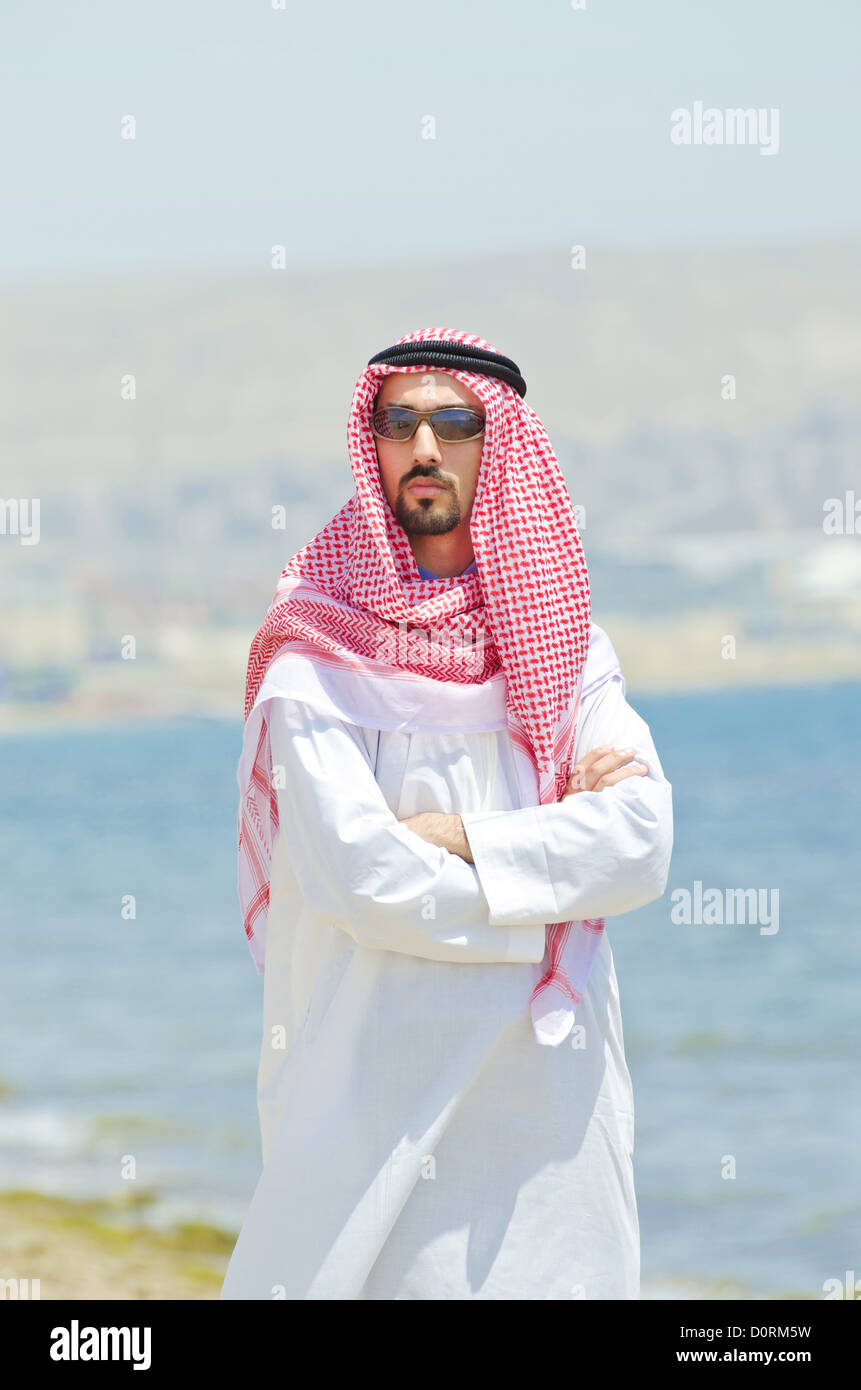 Arab on seaside in traditional clothing Stock Photo - Alamy