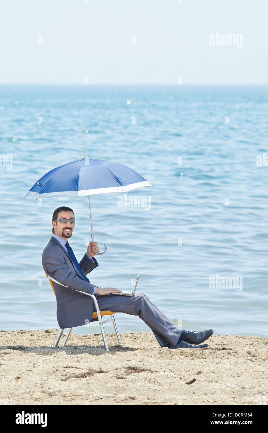Man with umbrella on seaside beach Stock Photo - Alamy