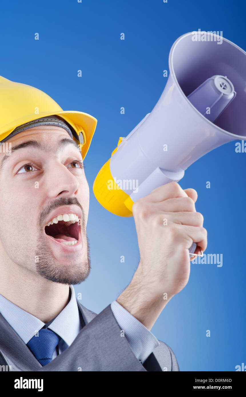 Construction worker shouting via loudspeaker Stock Photo - Alamy