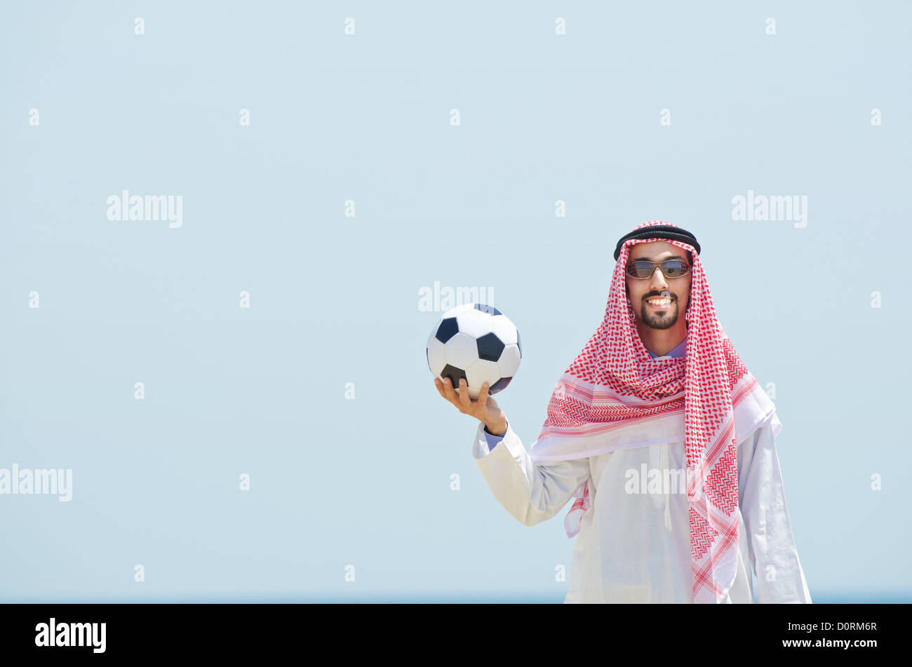 Arab with footbal at seaside Stock Photo - Alamy