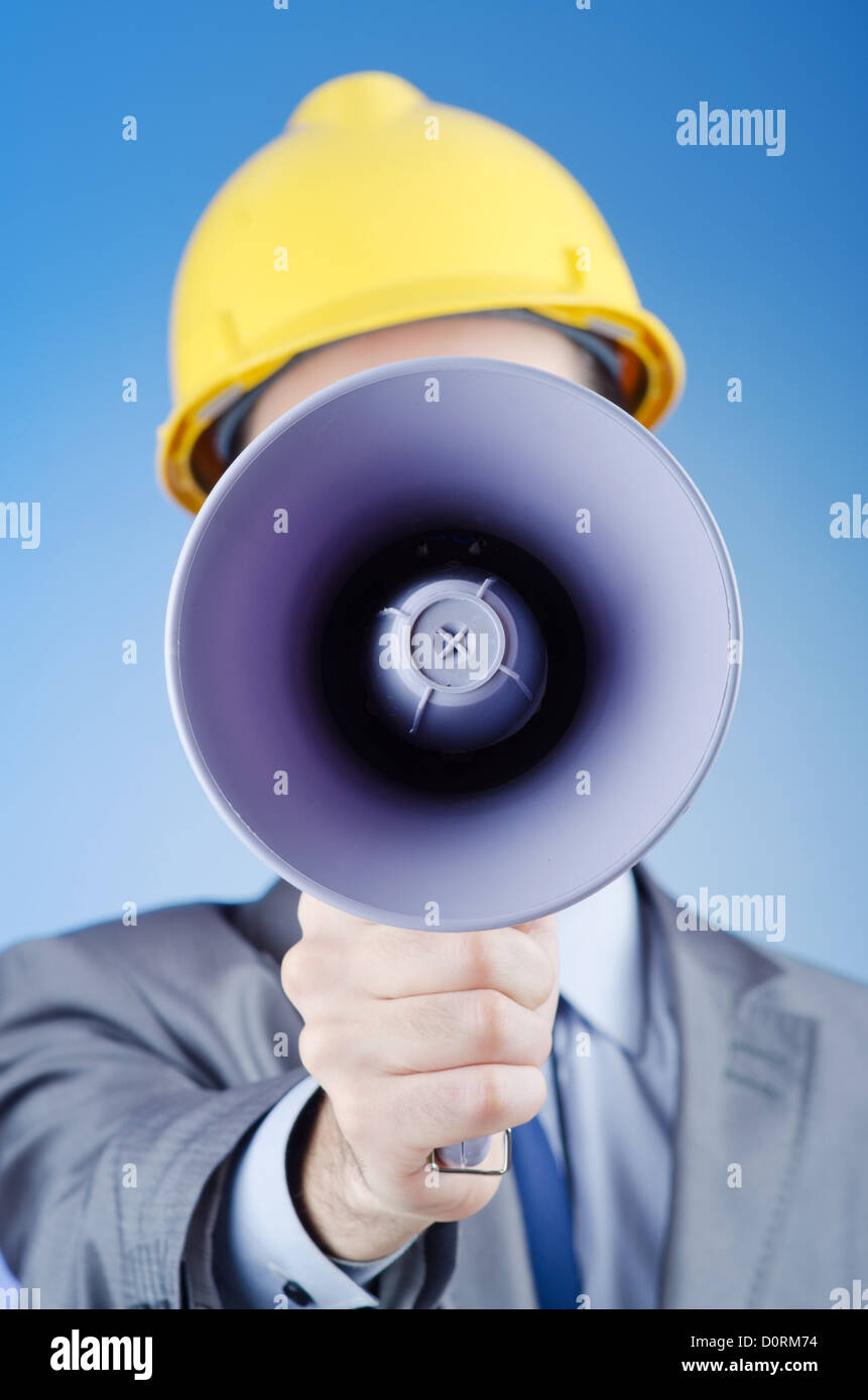 Construction worker shouting via loudspeaker Stock Photo - Alamy
