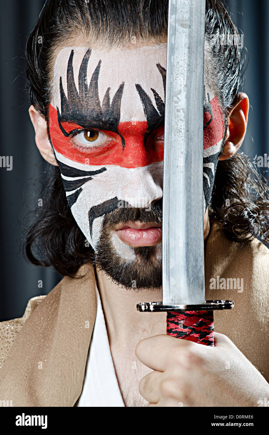 Man with face mask and sword Stock Photo - Alamy