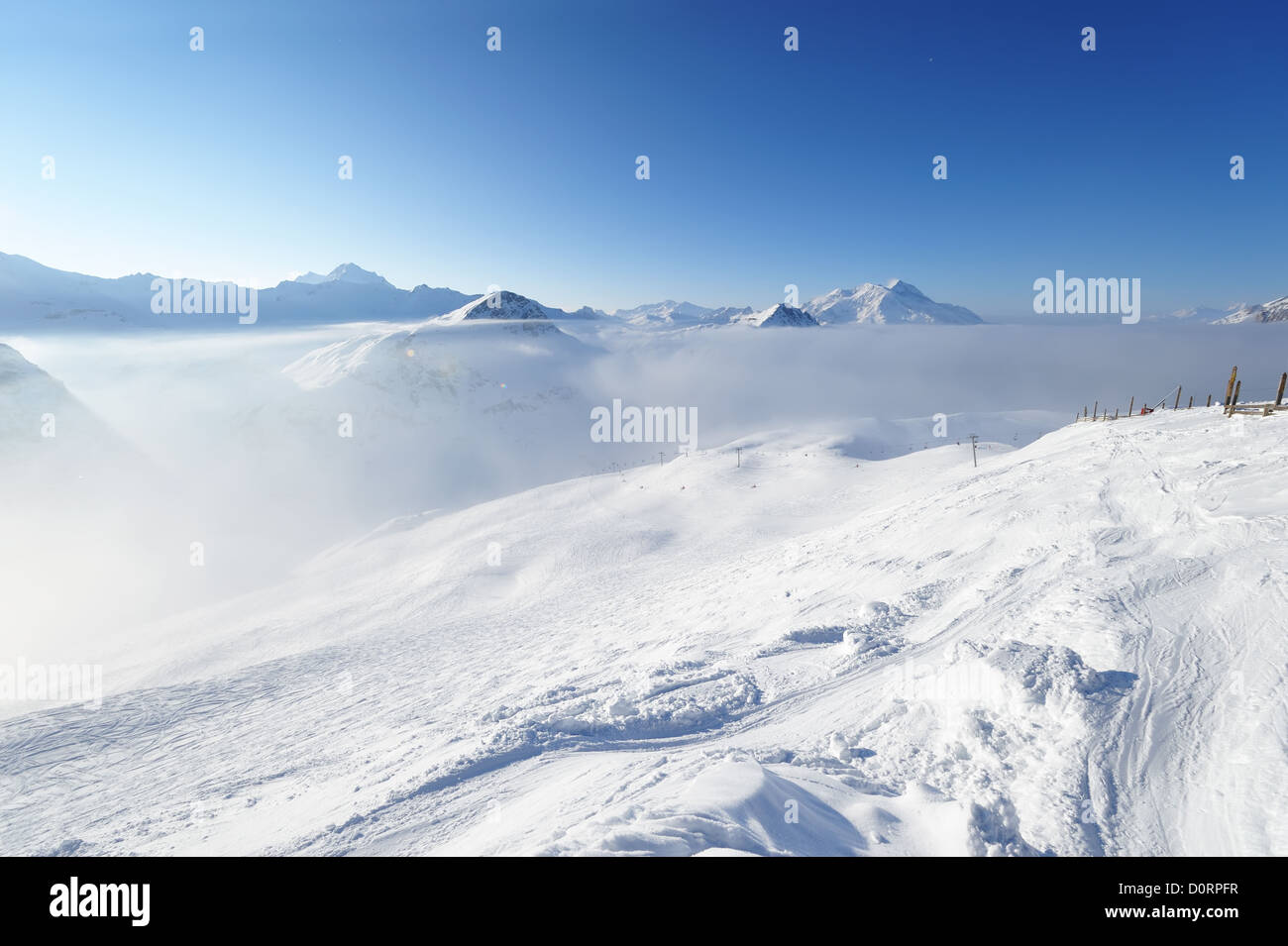 Mountains in clouds with snow in winter Stock Photo - Alamy