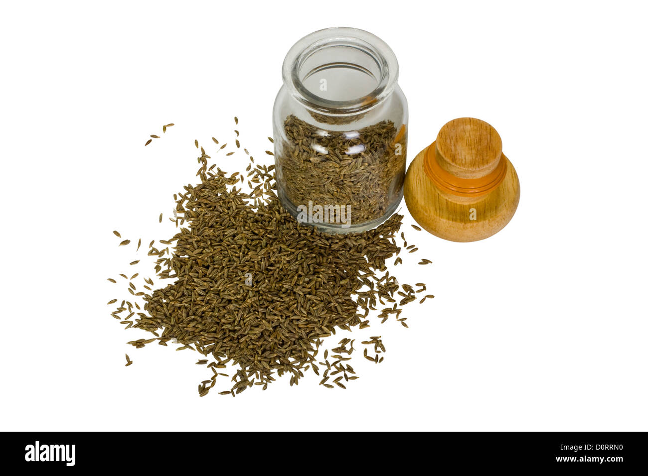 Cumin seed spilling out from a container Stock Photo - Alamy