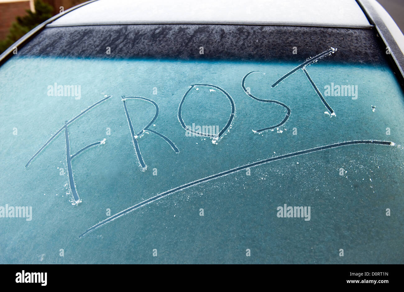 The word frost written on a frozen car screen Stock Photo - Alamy