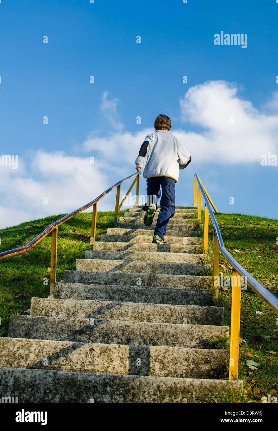 Boy climbing up steep hill hi-res stock photography and images - Alamy