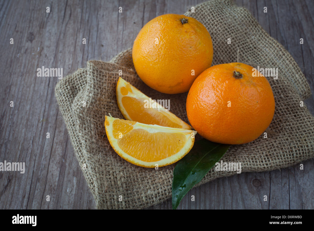 Bunch of fresh orange fruits on a wooden background Stock Photo - Alamy
