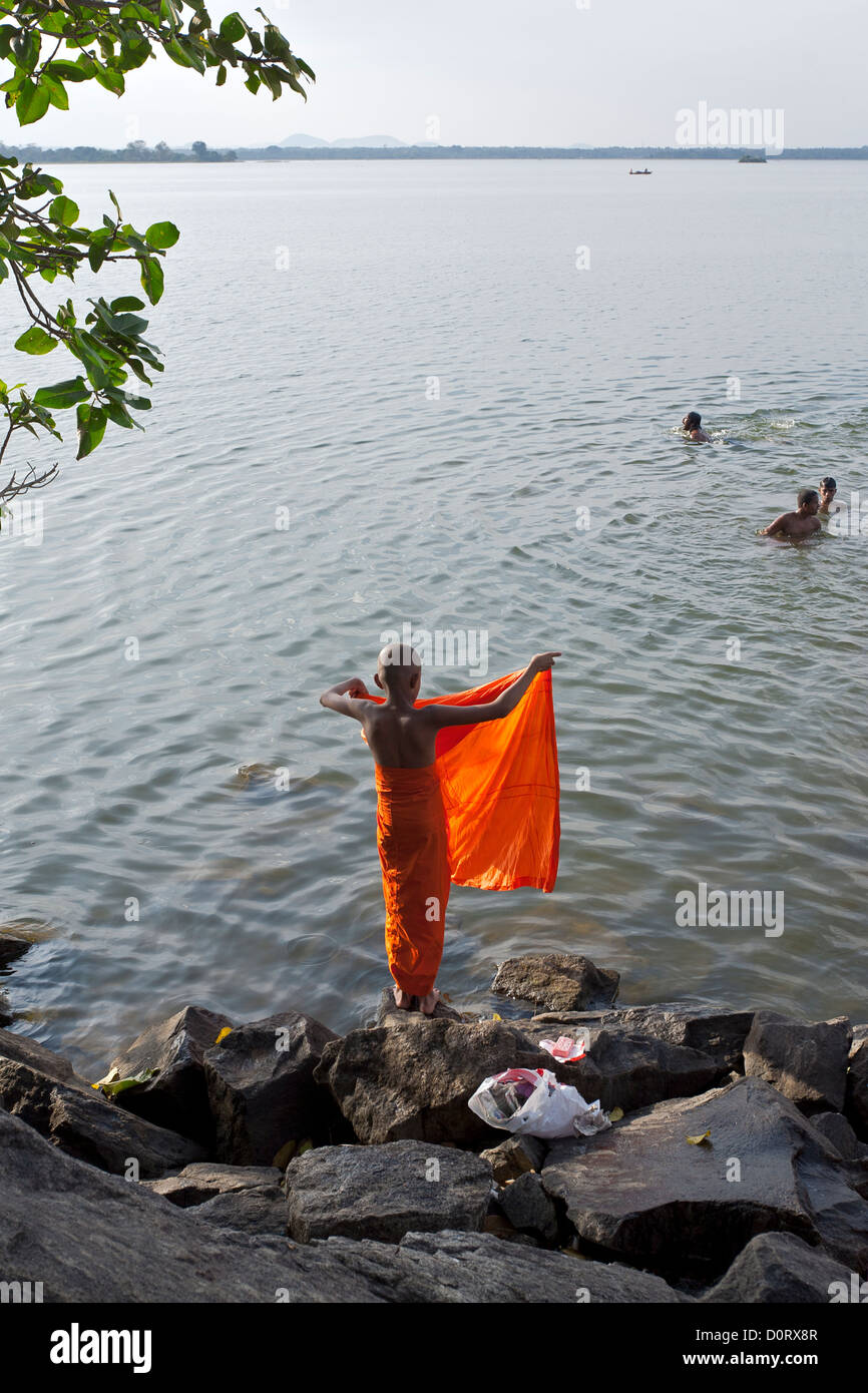 Buddhist novice monk drying his robe. Topa Wewa lake. Polonnaruwa. Sri ...