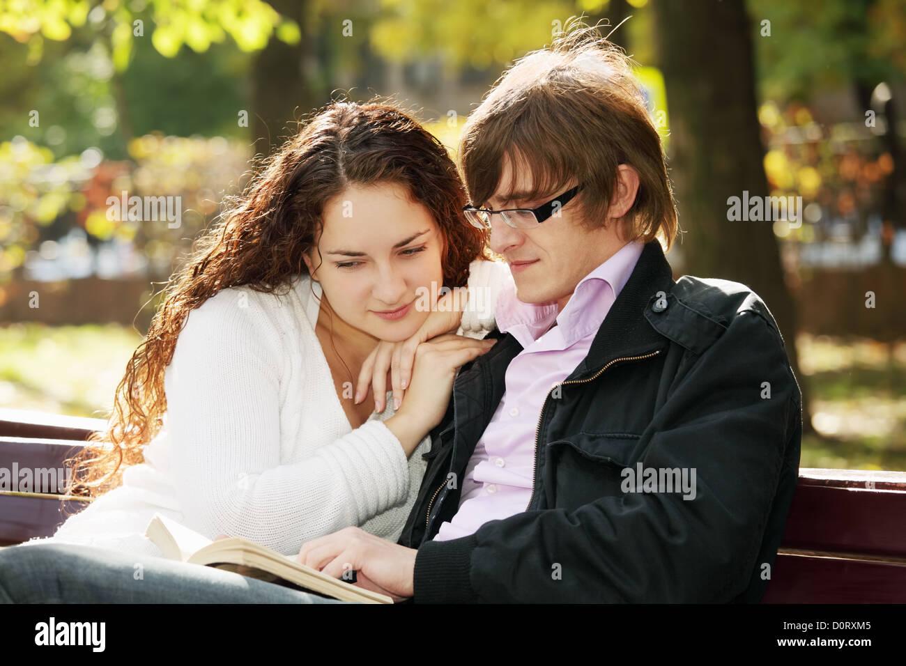Couple reading book Stock Photo - Alamy