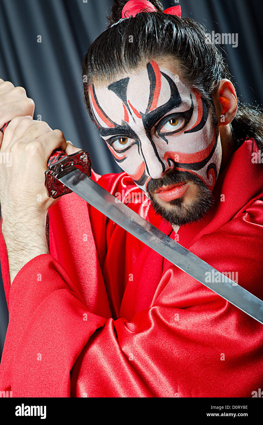 Man with face mask and sword Stock Photo - Alamy