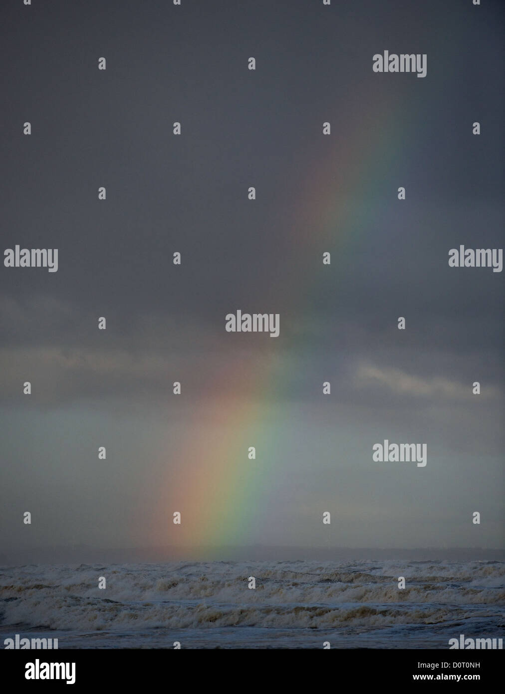 A rainbow forms over a wild north sea off the coast of Cleveland in ...