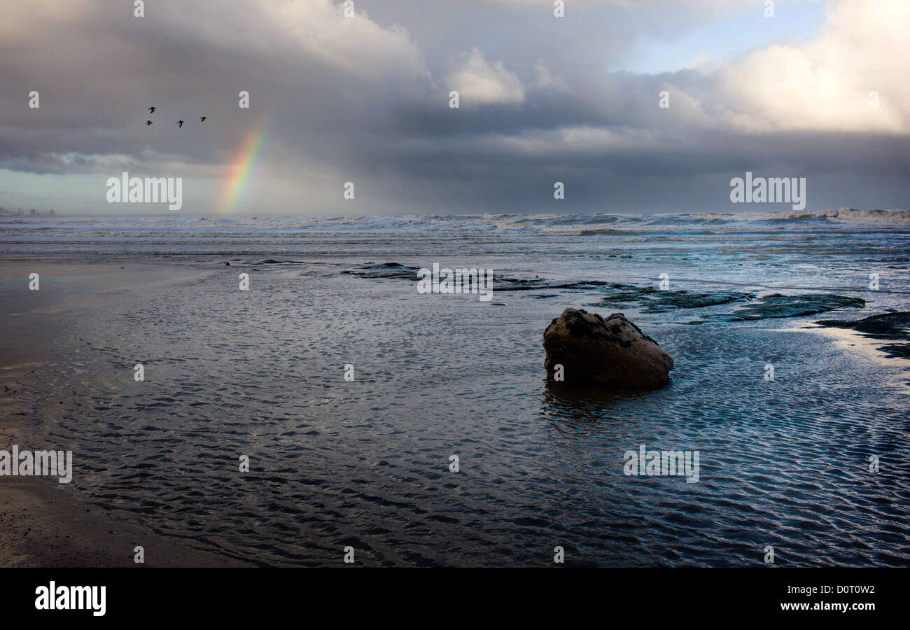 A rainbow forms over a wild north sea off the coast of Cleveland in ...