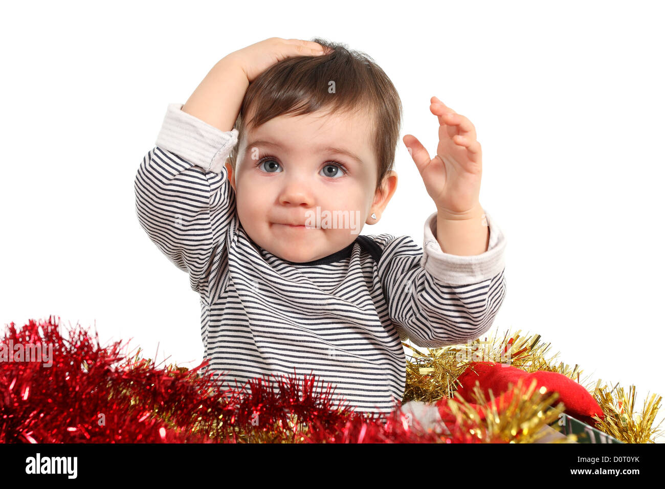 Eight months baby inside a box with christmas ornaments in a white ...