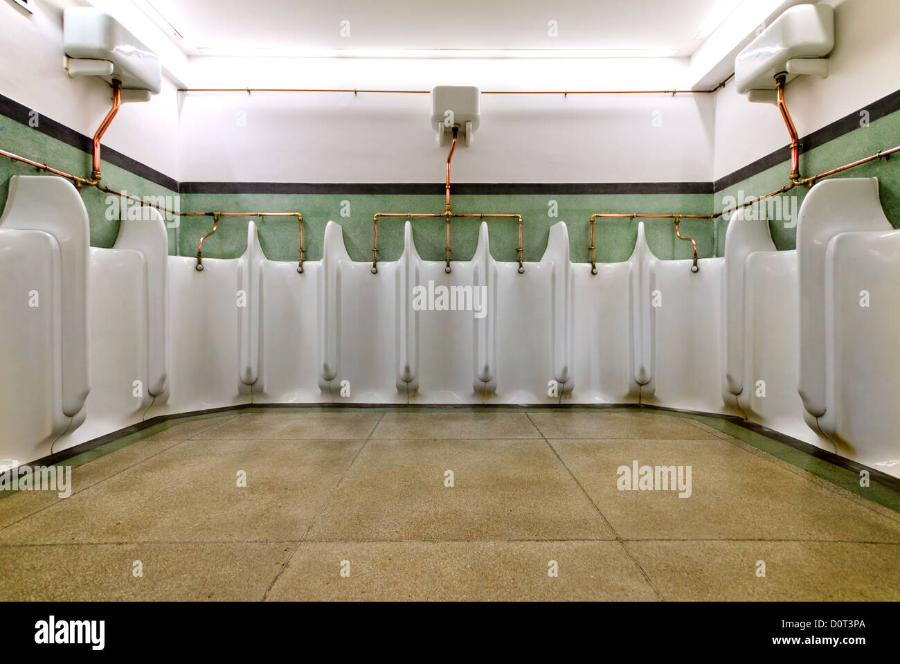 Old fashioned men's urinals. Wideangle view Stock Photo - Alamy