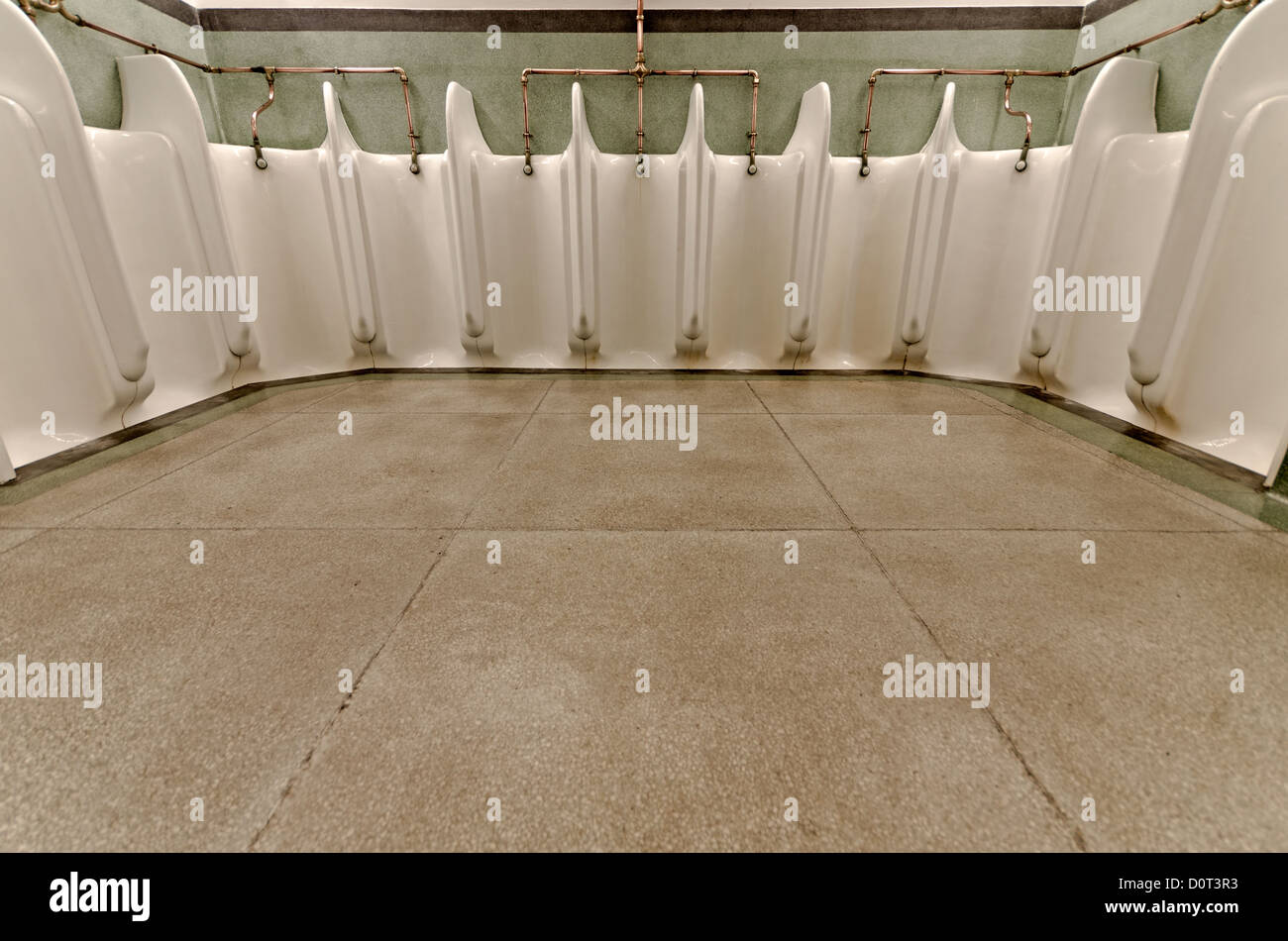 Old fashioned men's urinals. Wideangle view Stock Photo - Alamy