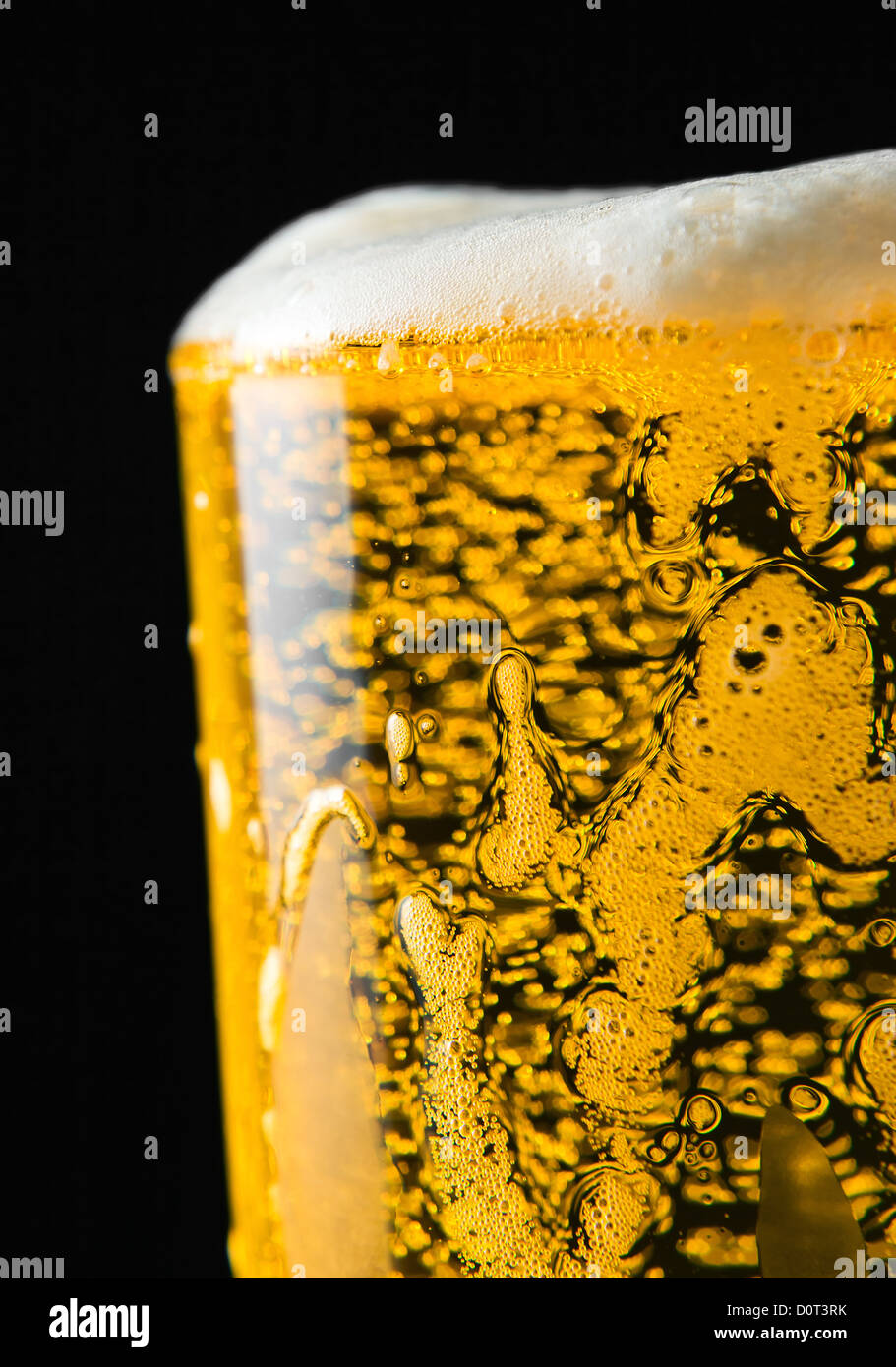 Beer glass with froth over black background Stock Photo - Alamy