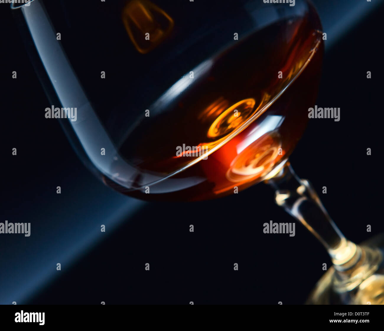 snifter with brandy on a dark background Stock Photo - Alamy