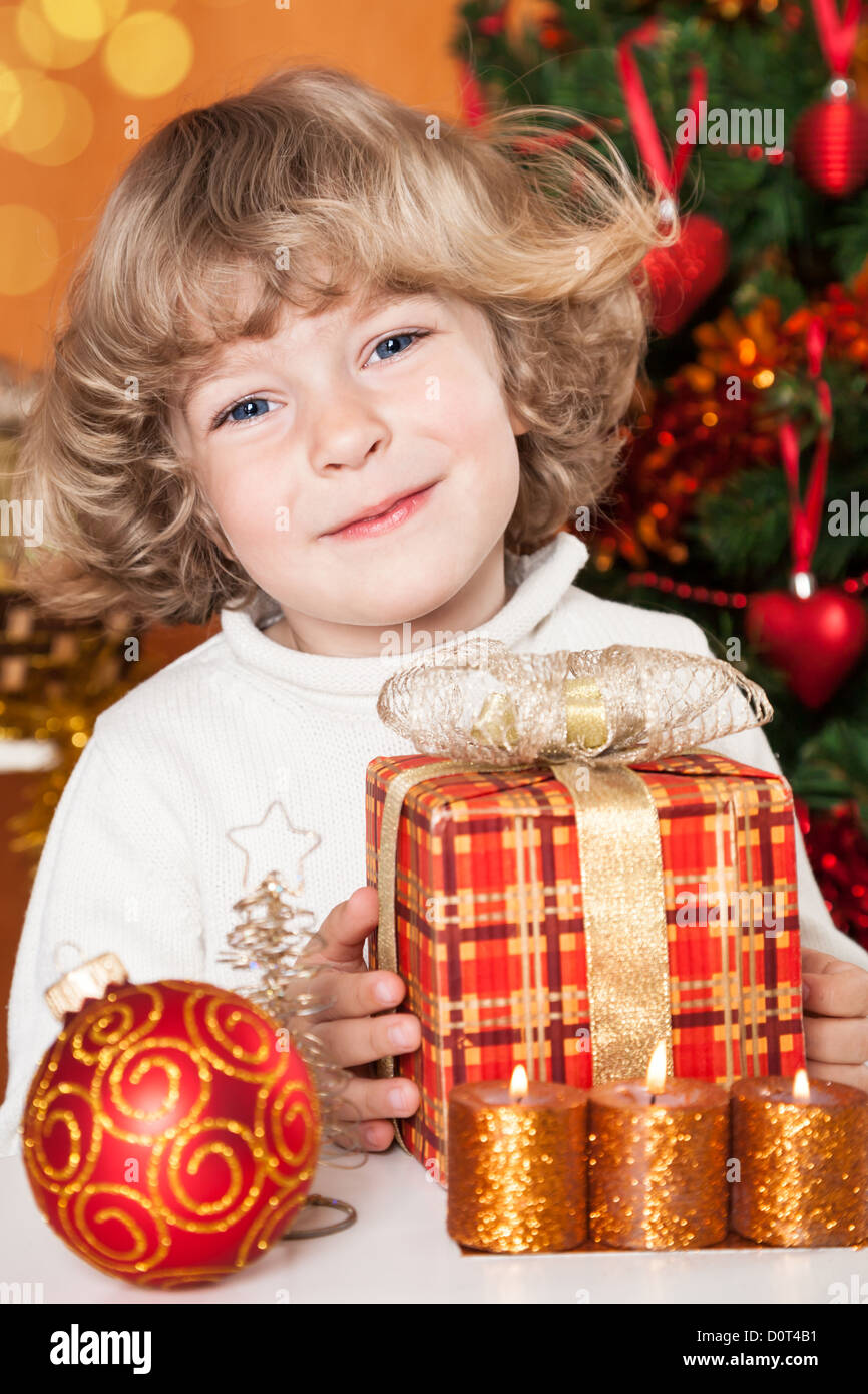 Smiling child holding present Stock Photo - Alamy
