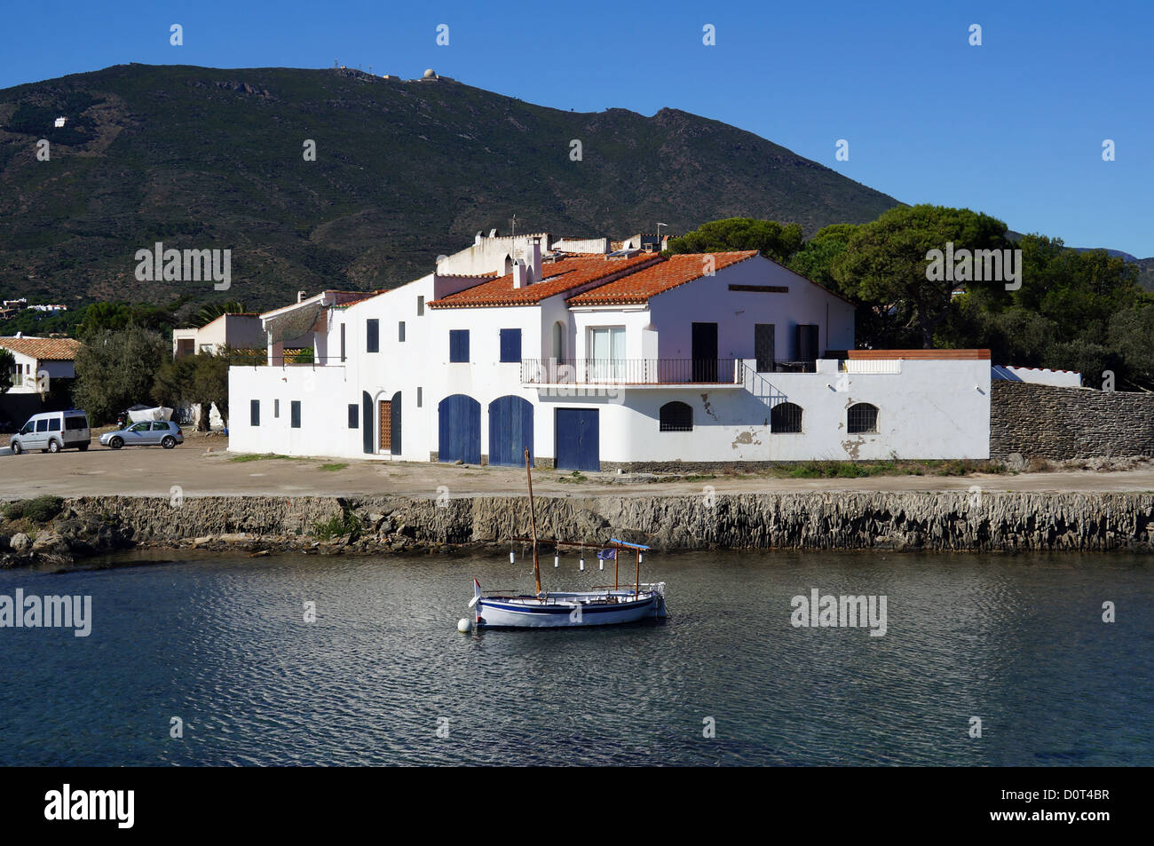 Waterfront Mediterranean house with a Catalan boat in foreground ...