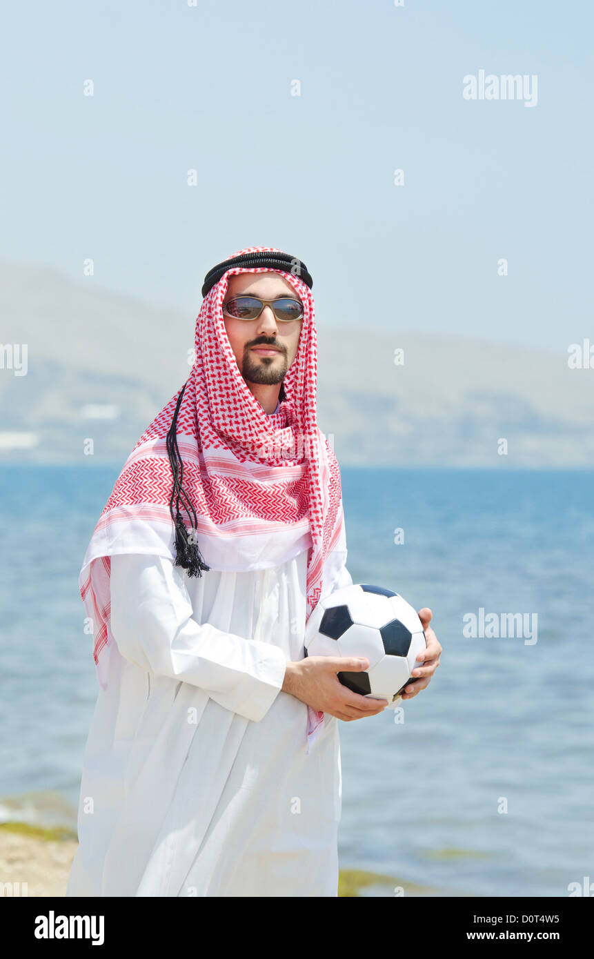 Arab with footbal at seaside Stock Photo - Alamy
