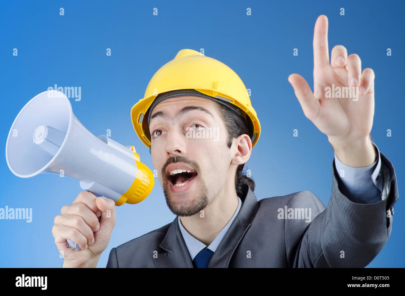 Construction worker shouting via loudspeaker Stock Photo - Alamy