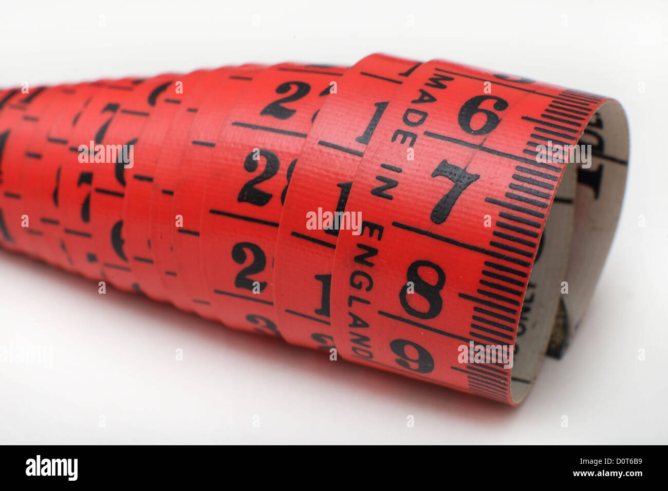 A ROLLED UP RED TAPE MEASURE. PHOTOGRAPHED BY JAMIE MANN Stock Photo ...